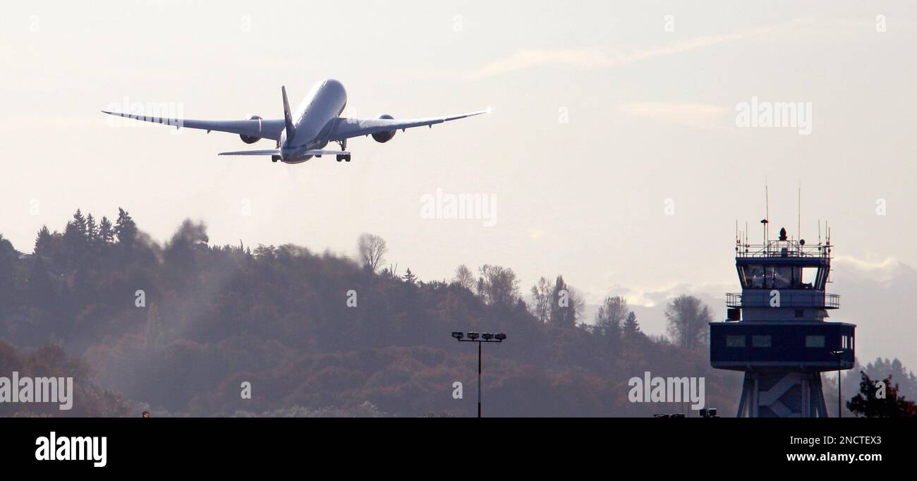 A test model Boeing 787 takes off in view of a flight tower at Boeing ...
