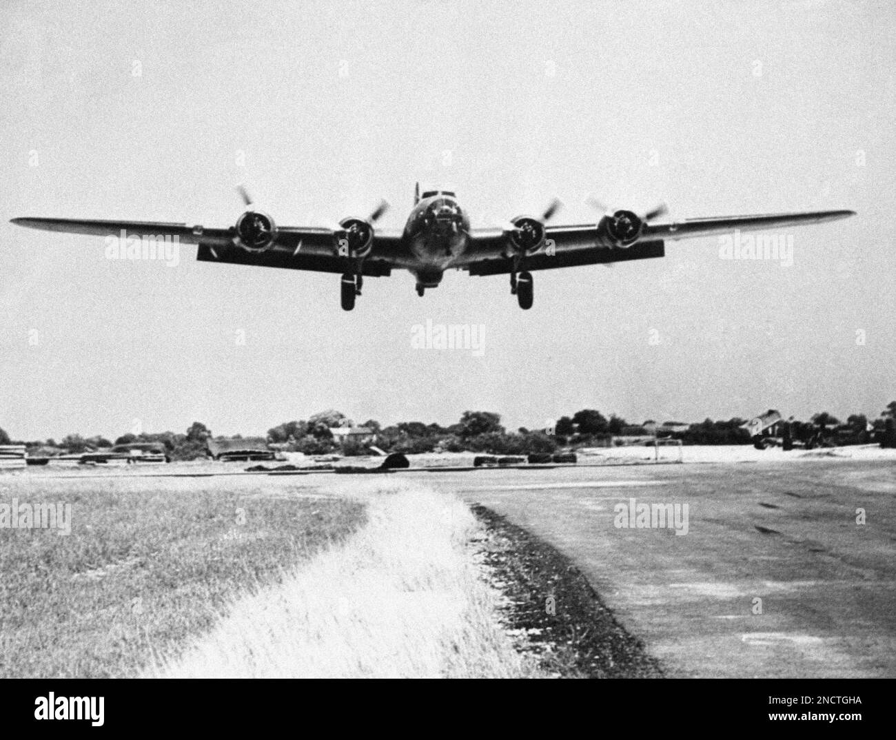 A giant American-made Boeing Flying Fortress coming to a landing on a ...
