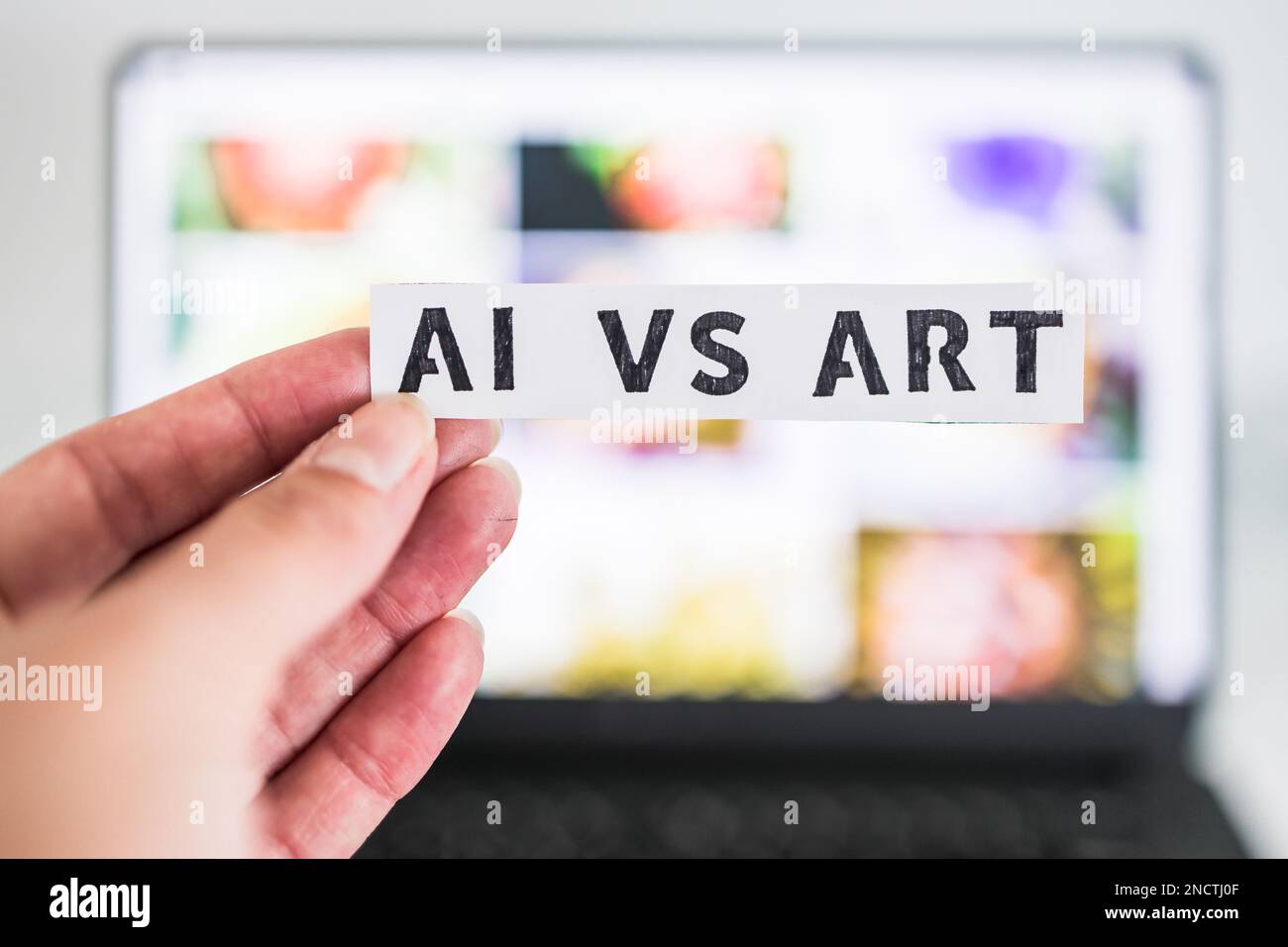 AI vs Art text in front of laptop bokeh with out of focus images ...