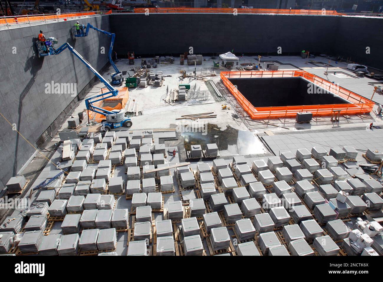 Construction workers continue building one of the memorial waterfalls ...