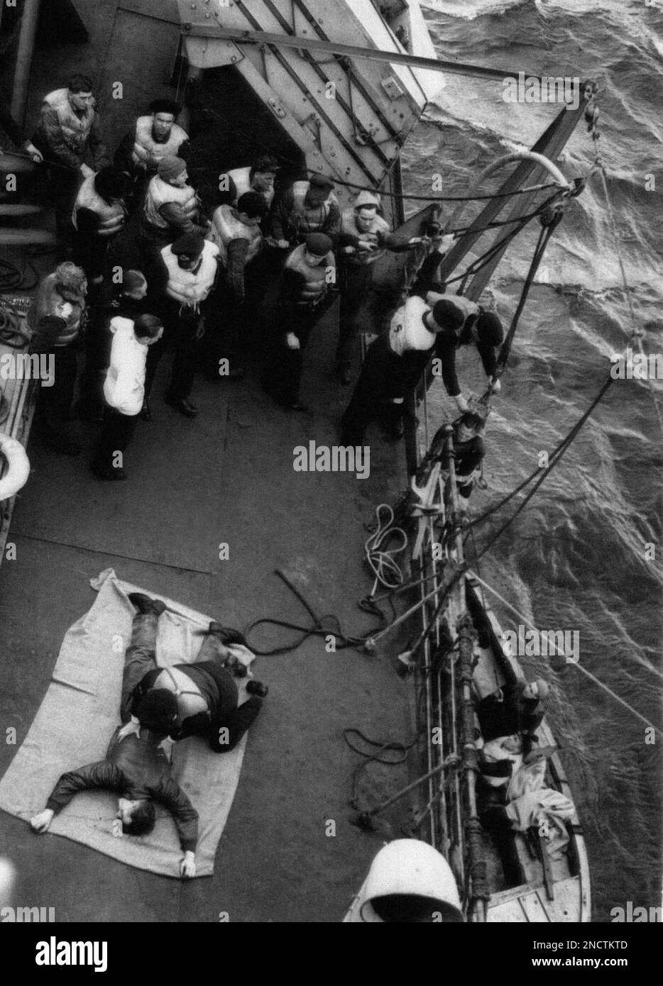 As the stretcher case is brought aboard the British rescue ship one of ...