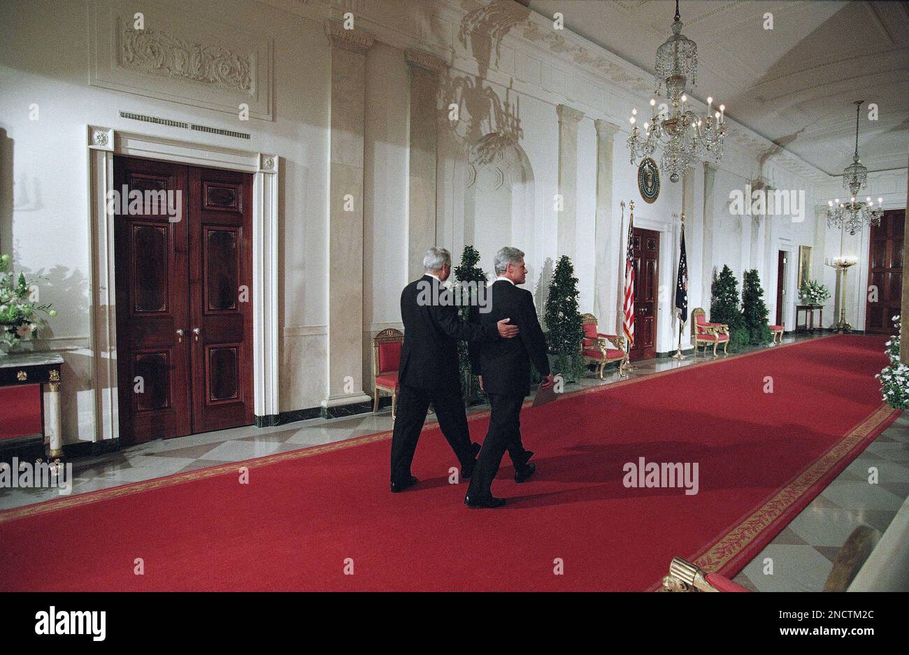 Russian President Boris Yeltsin puts his hand on the back of President ...