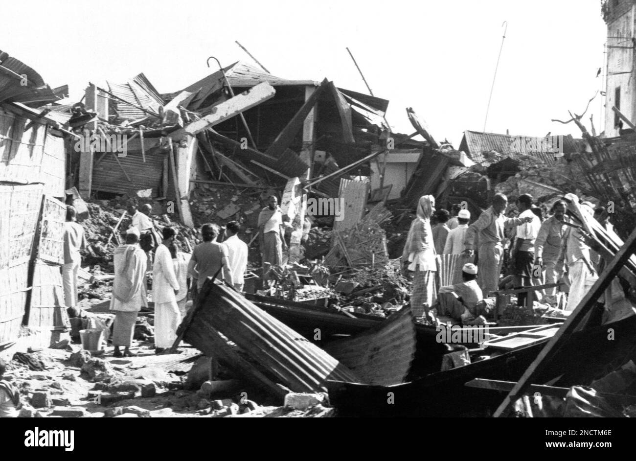Crowd surveys the damage in this housing area of Dacca, East Pakistan ...