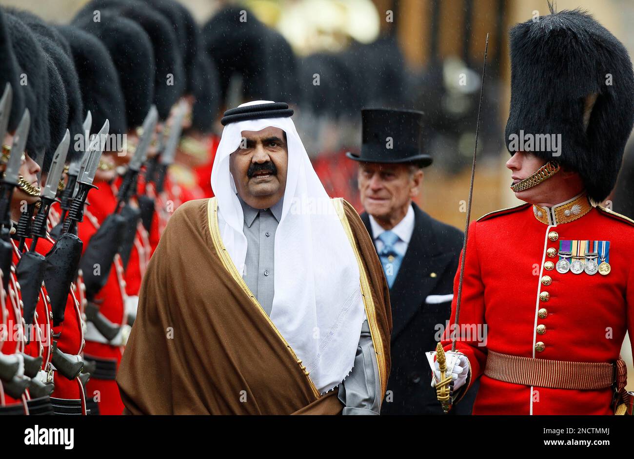 The Emir of Qatar Sheik Hamad bin Khalifa Al-Thani, left, inspects the ...
