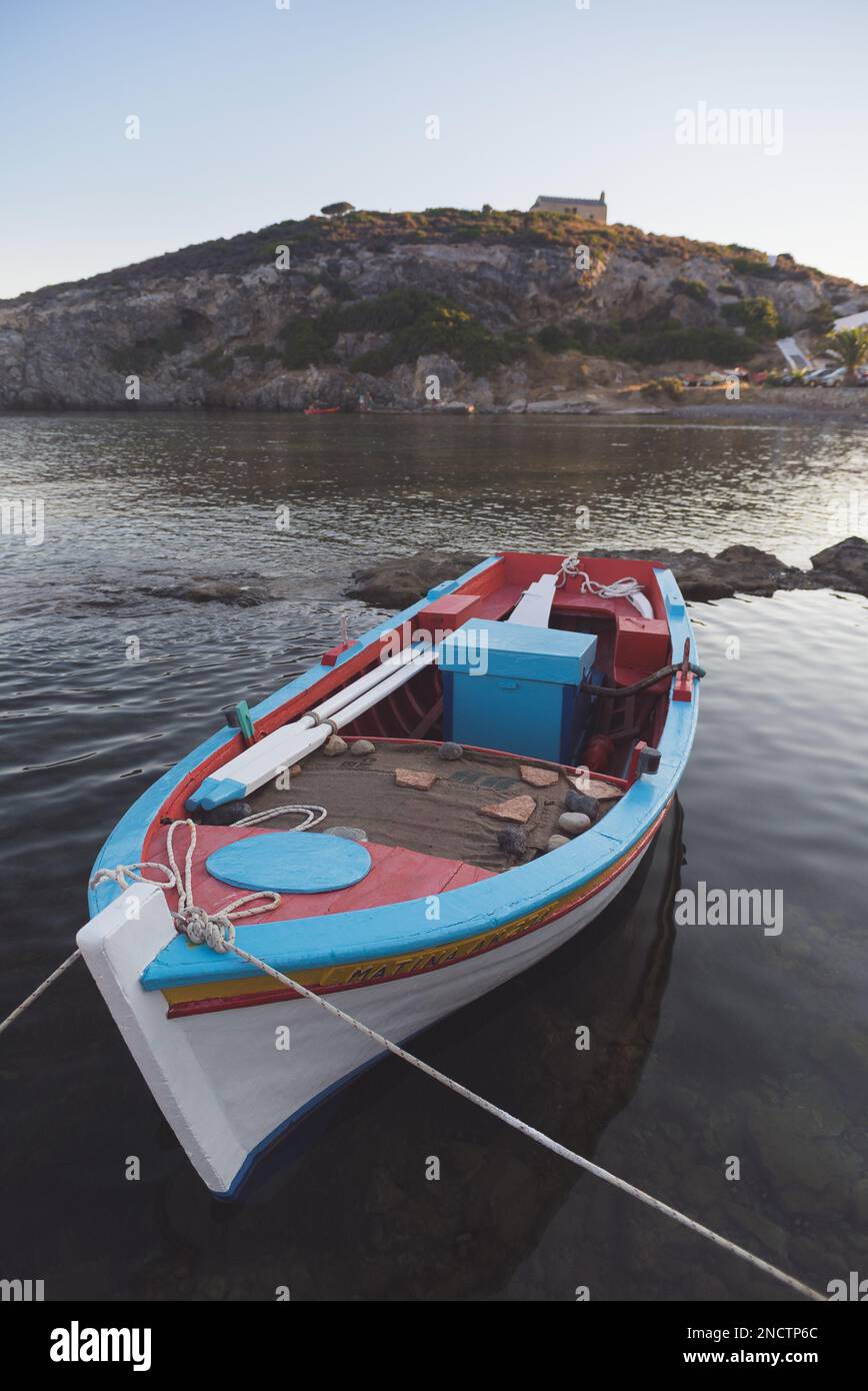 A small boat tied up to a dock in the water Stock Photo - Alamy