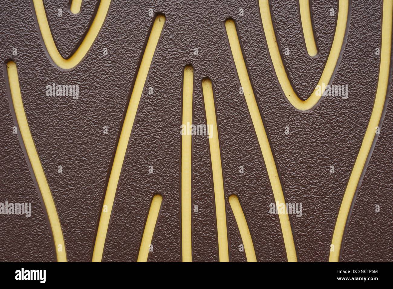 yellow indented lines on a brown jagged background Stock Photo - Alamy