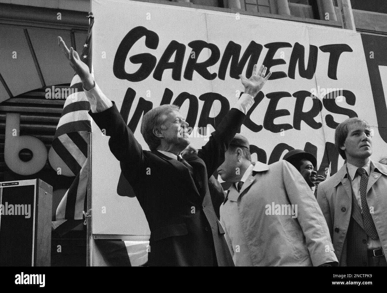 U.S. President Jimmy Carter stretches out his arms while addressing the ...