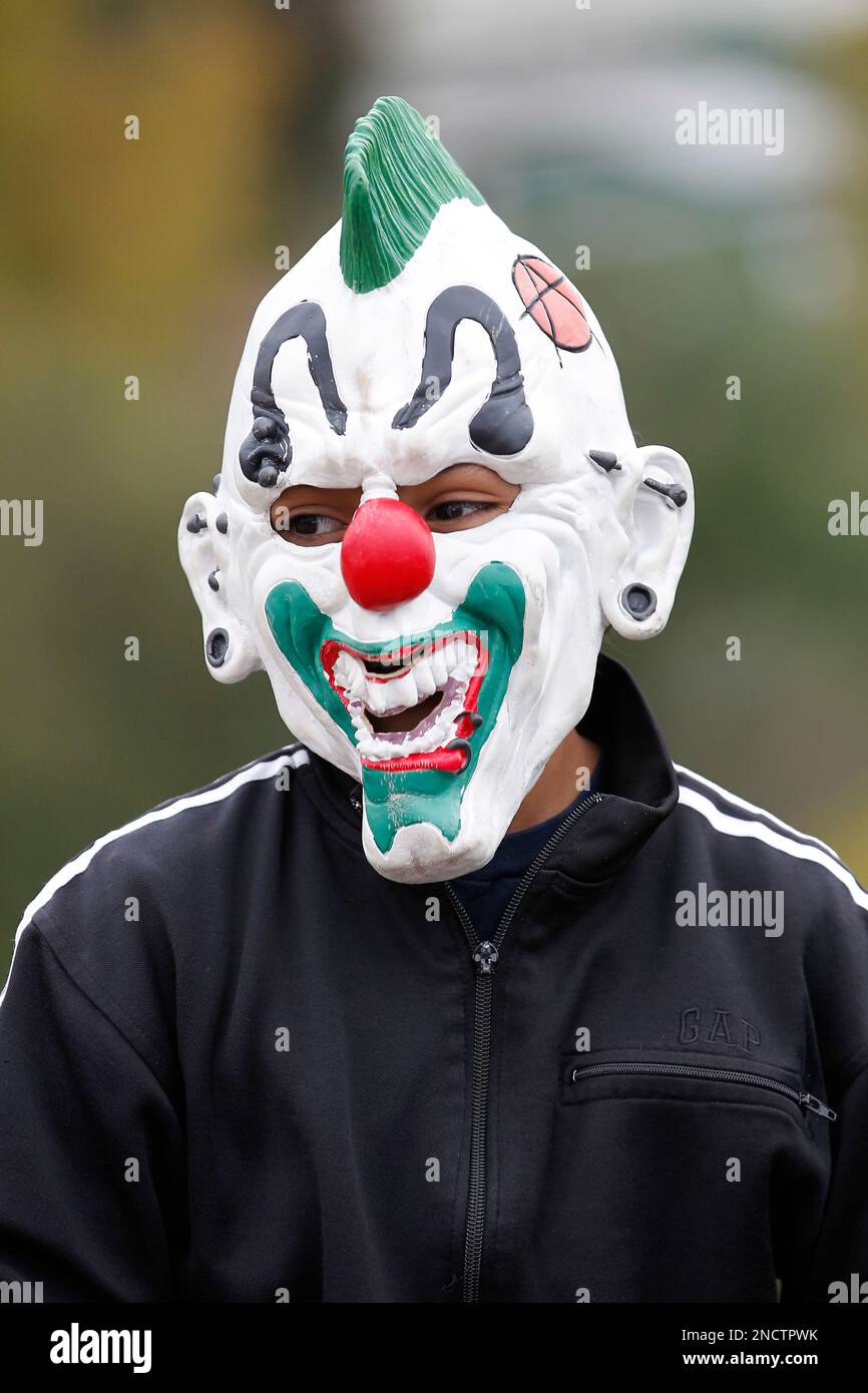 David Smith, from the Boys and Girls Club wears a clown mask during the ...