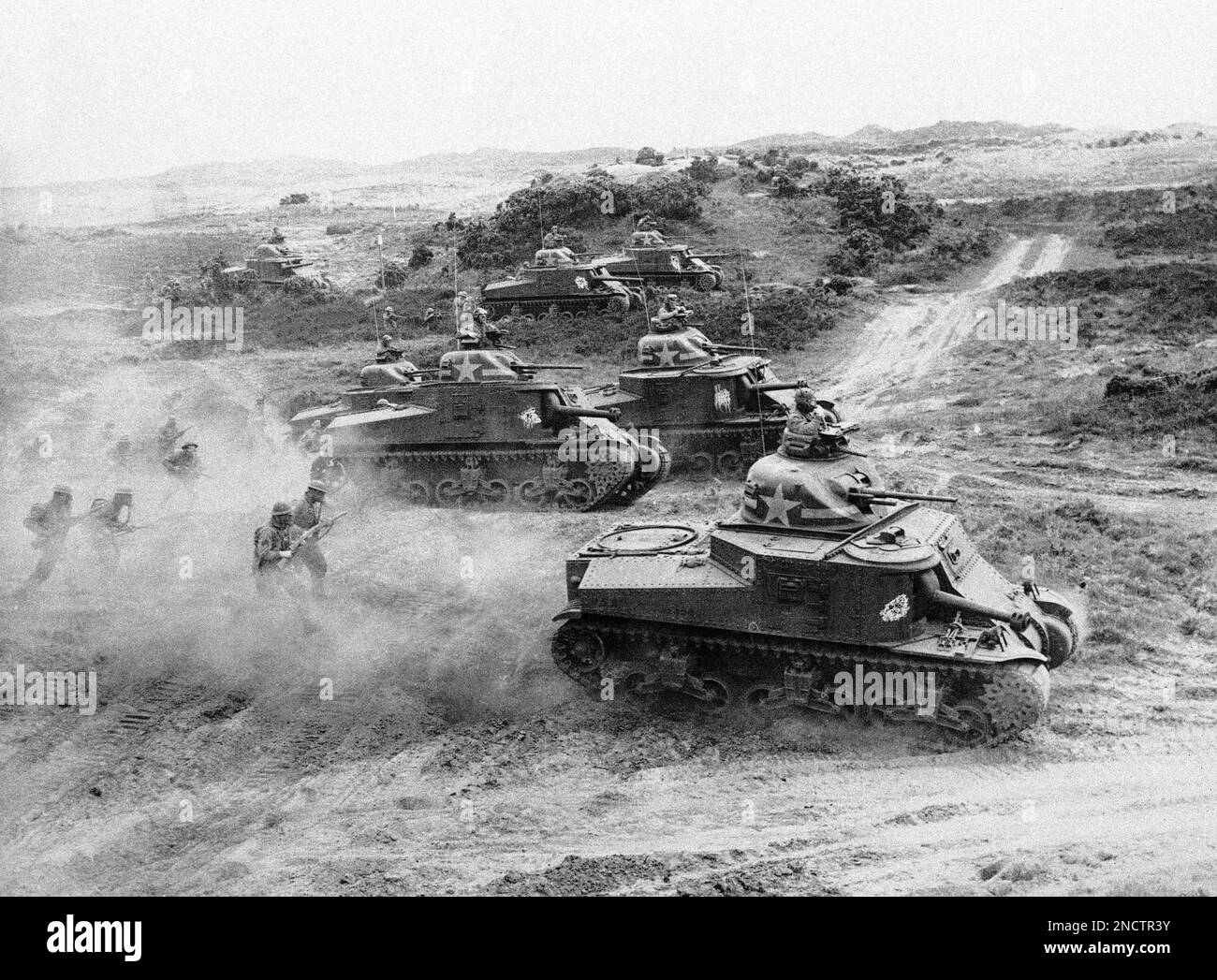 Closely followed by infantry, American General Grant tanks roll through ...