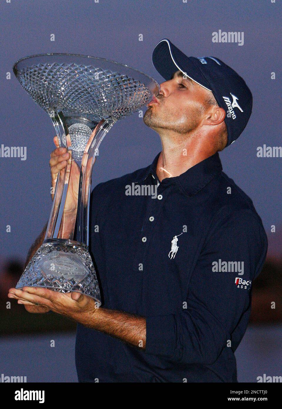 Jonathan Byrd kisses the trophy after sinking a hole-in-one on the fourth playoff hole to win ...