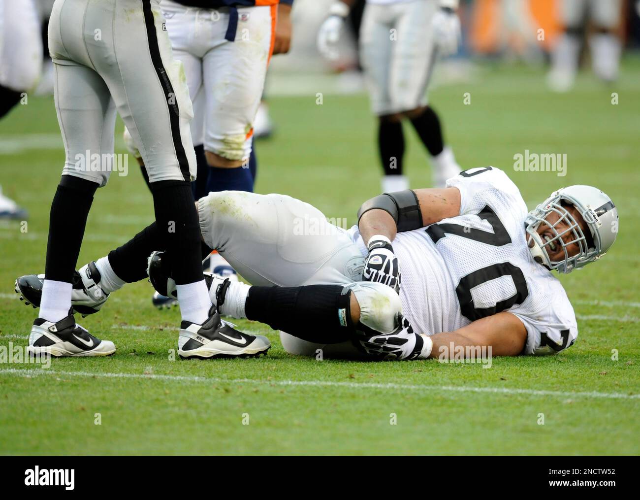 Oakland Raiders offensive tackle Langston Walker rolls over with an ...