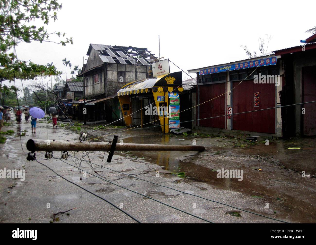 In this photo taken Saturday, Oct. 23, 2010, storm victims walk on a ...