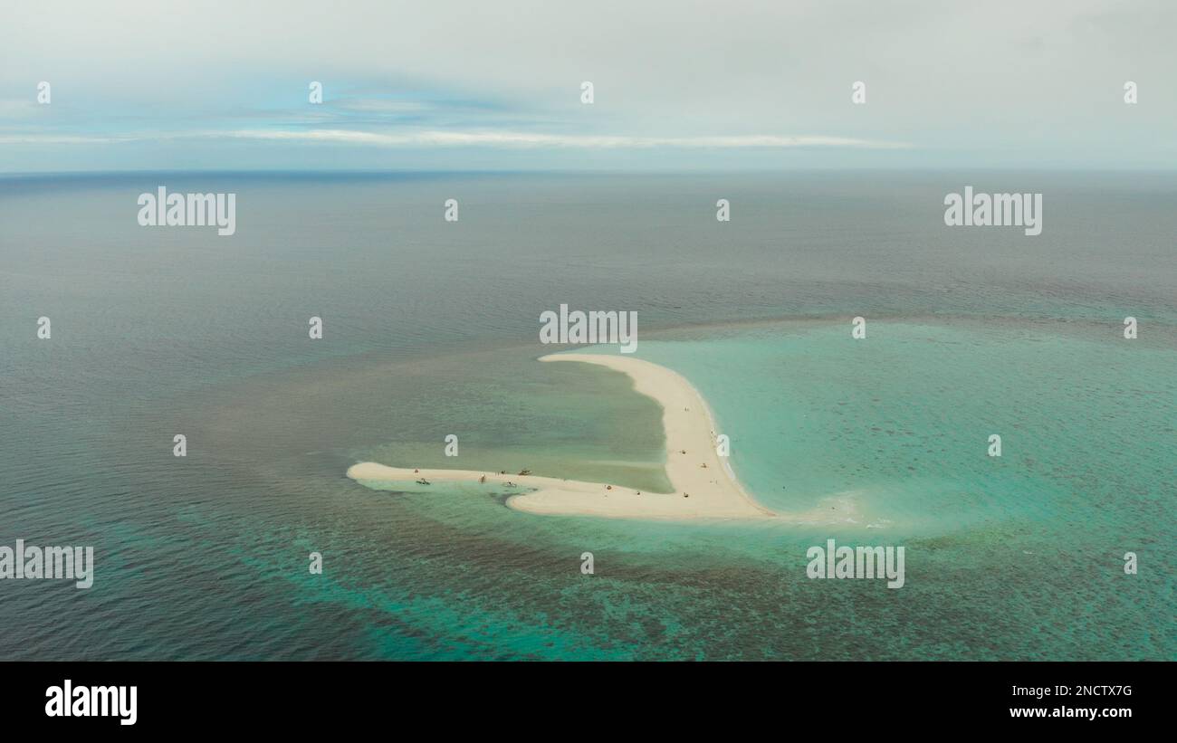 Tropical white island and sandy beach with tourists surrounded by coral ...