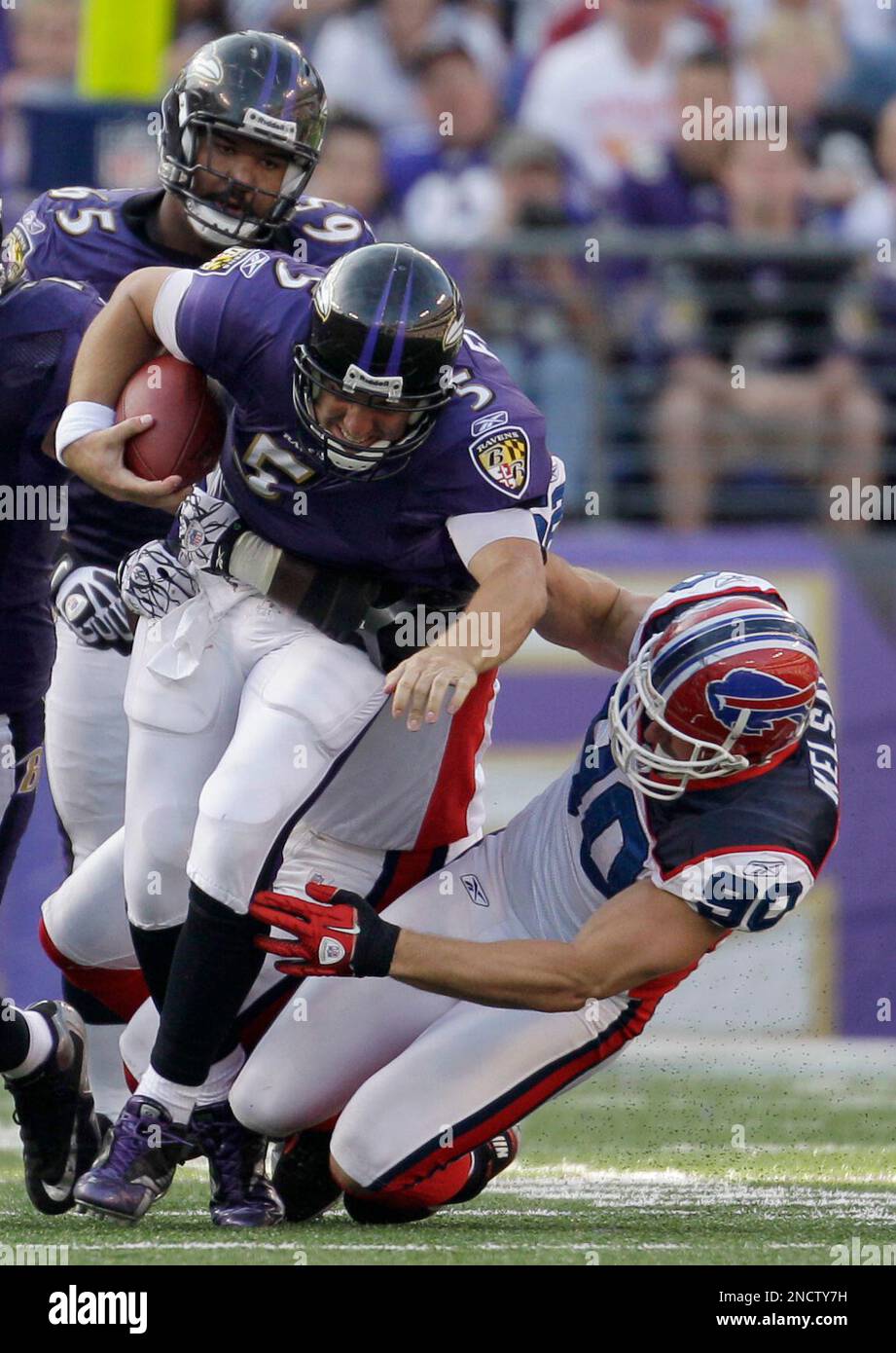 Baltimore Ravens quarterback Joe Flacco (5) is tackled by Buffalo Bills ...