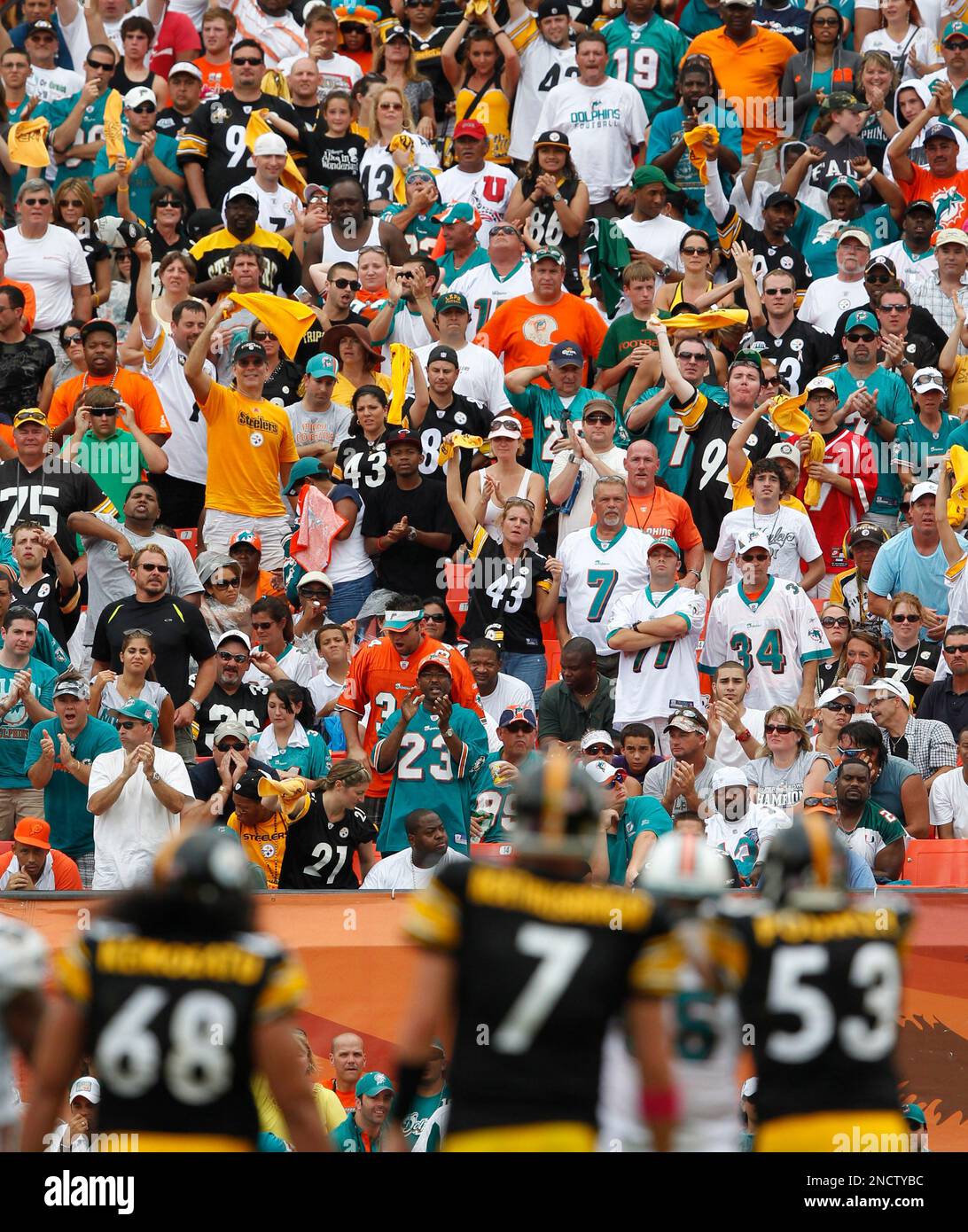 Football fans cheer as players position themselves during the second ...
