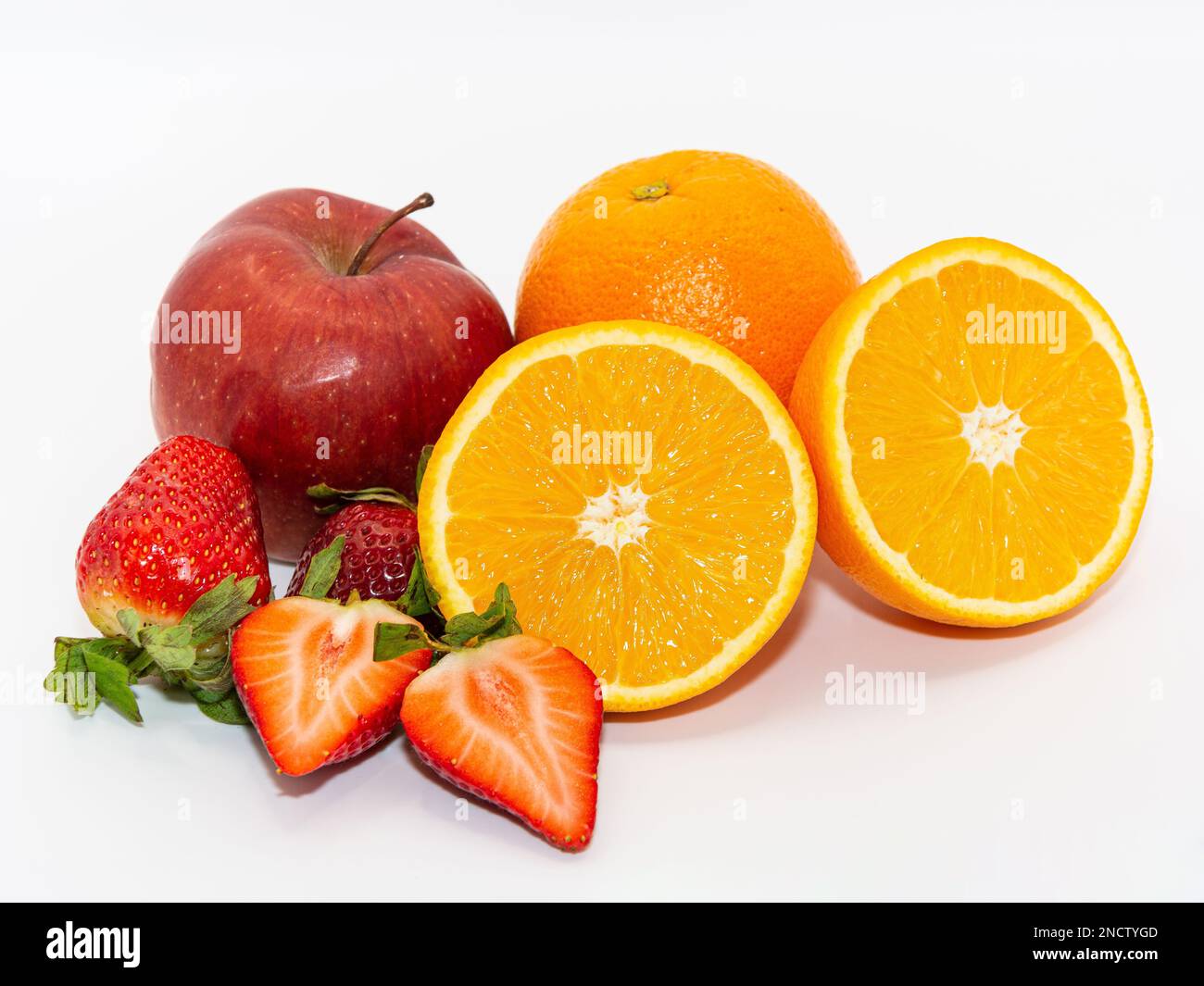 The delicious fresh juicy whole and halved fruits isolated on white ...