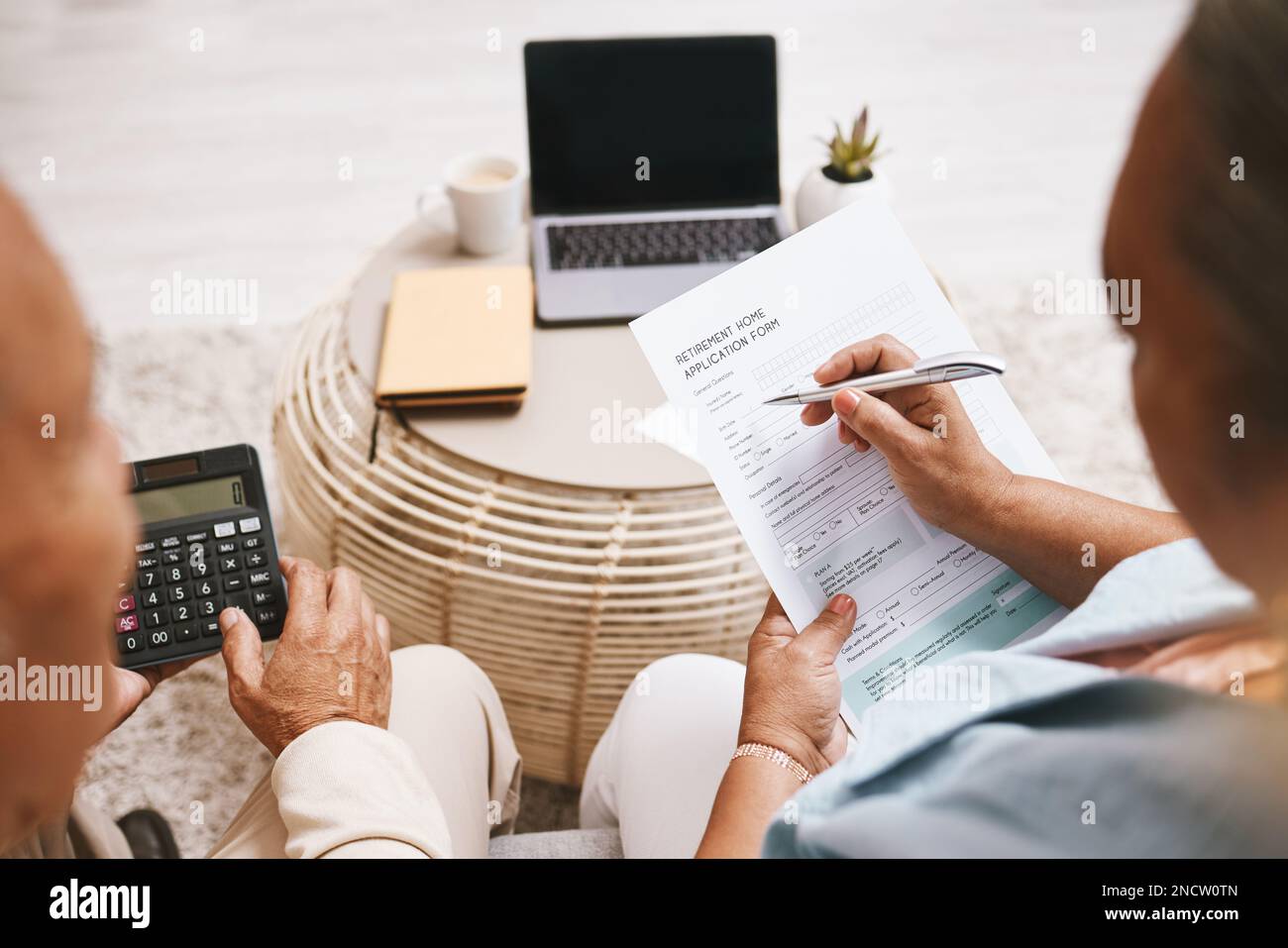 Top view of couple, retirement home application documents and planning ...