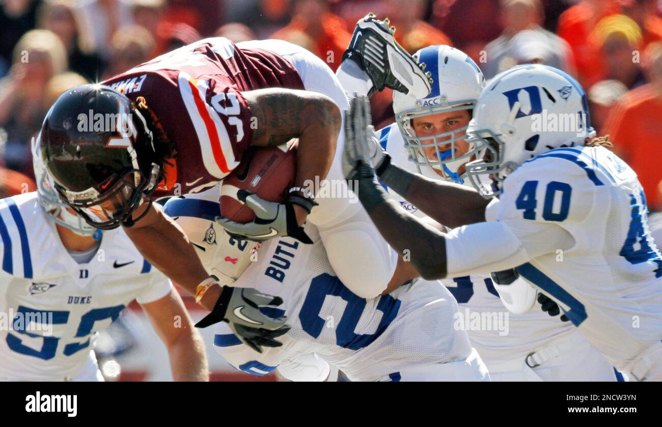Virginia Tech running back Darren Evans (32) goes over the top of Duke ...