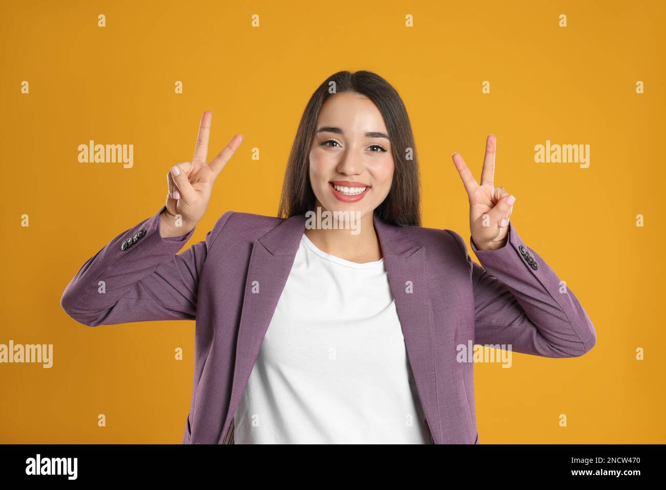 Woman in violet blazer showing number four with her hands on yellow ...