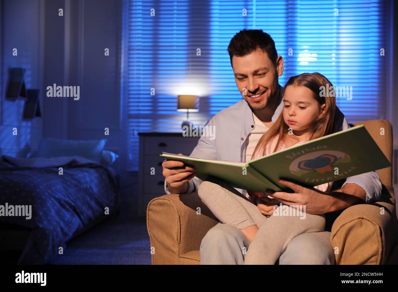 Father reading bedtime story to his daughter at home Stock Photo - Alamy