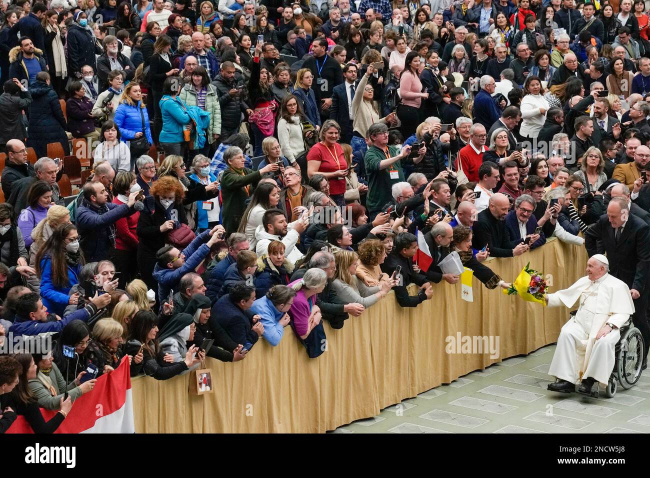 Pope Francis is offered flowers during his weekly general audience in ...