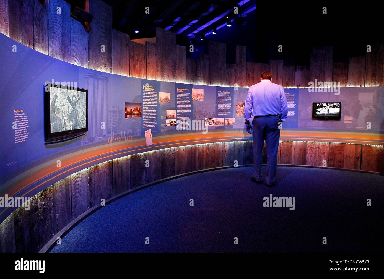 A visitor reads a display at "Living with Hurricanes: Katrina & Beyond ...