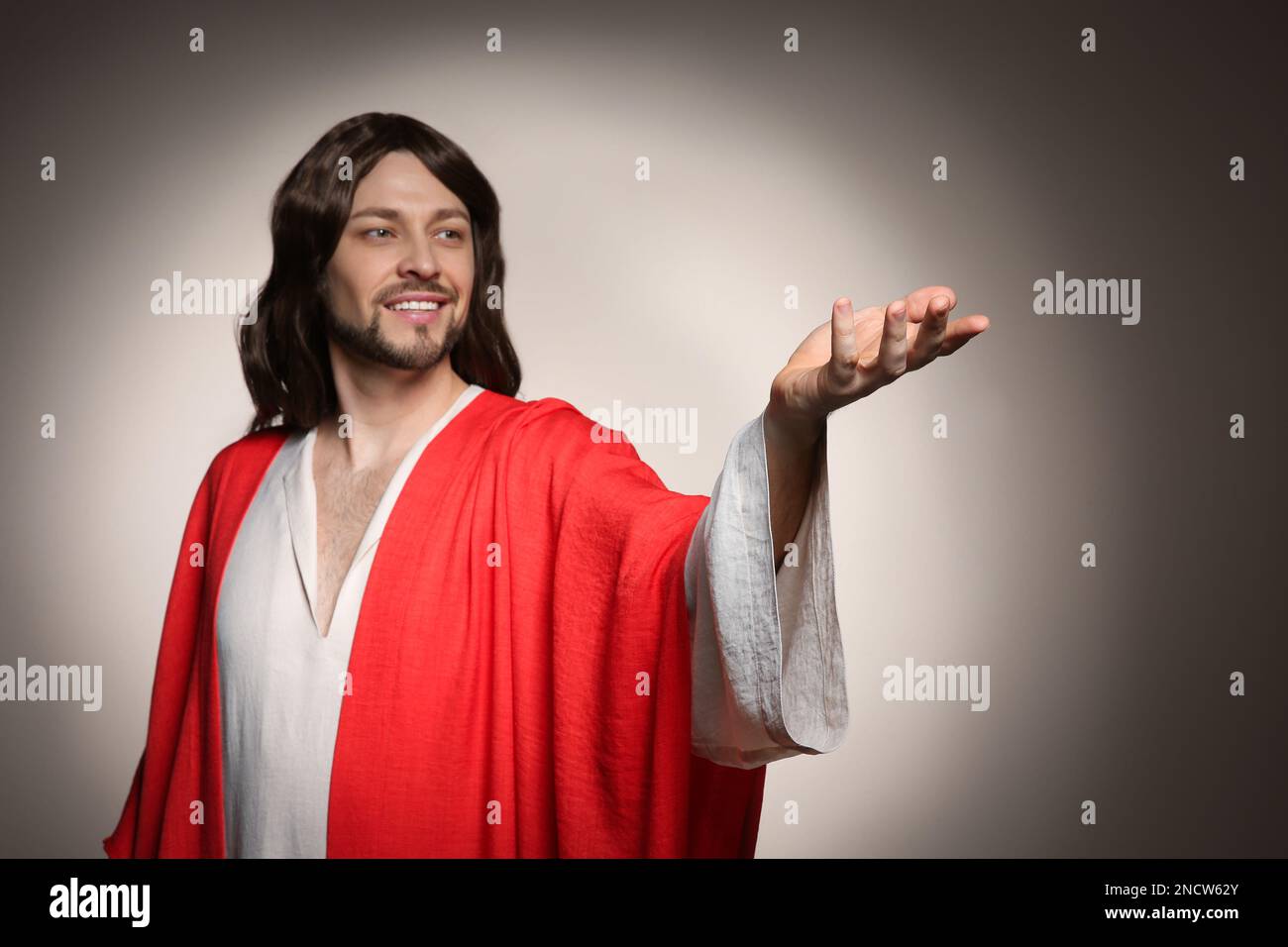 Jesus Christ reaching out his hand on beige background Stock Photo - Alamy