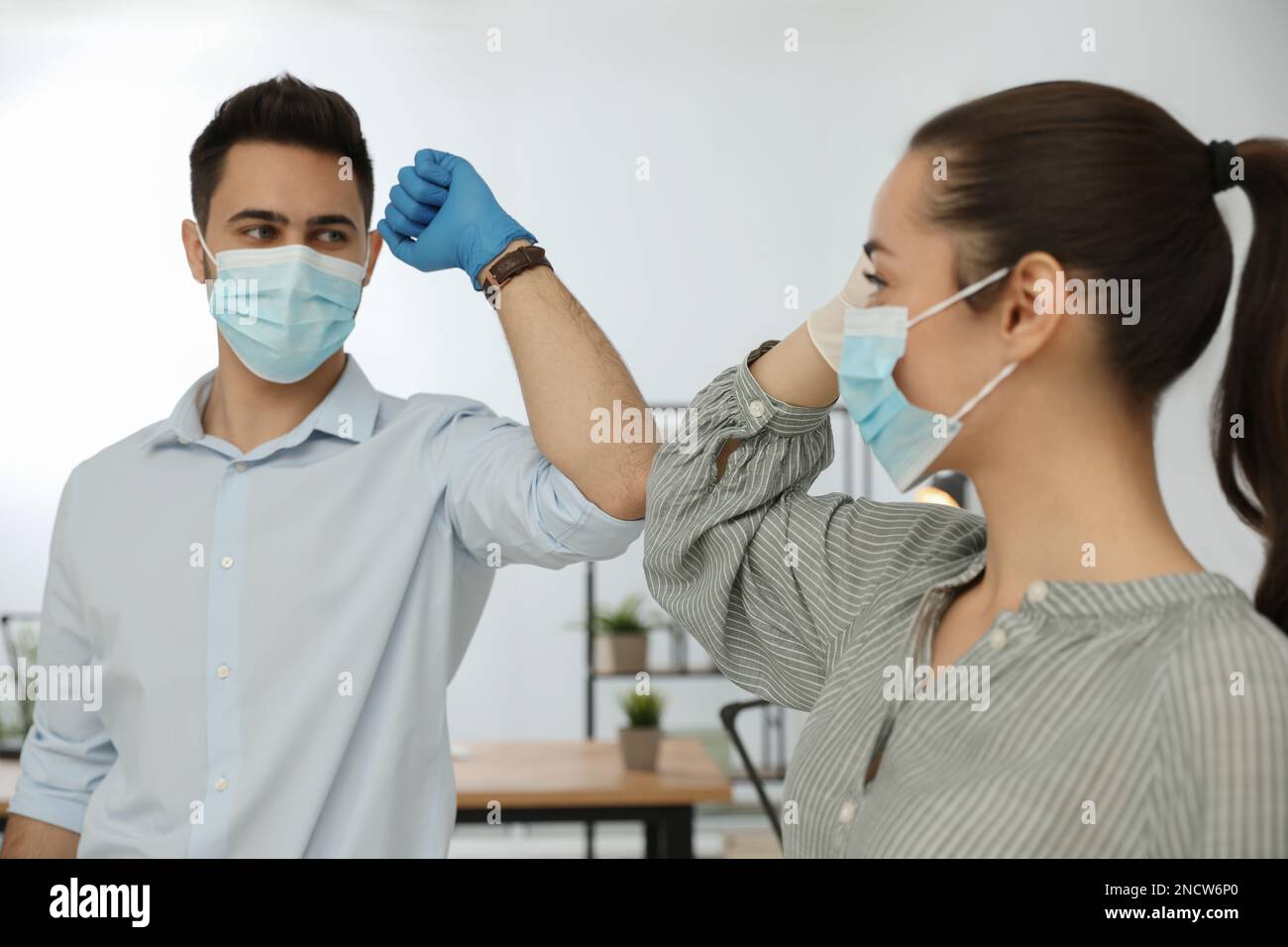 People greeting each other by bumping elbows instead of handshake in ...