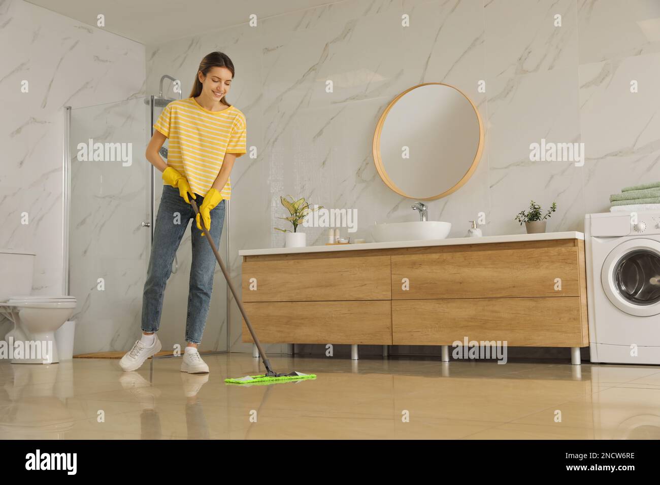 Woman cleaning floor with mop at home Stock Photo - Alamy