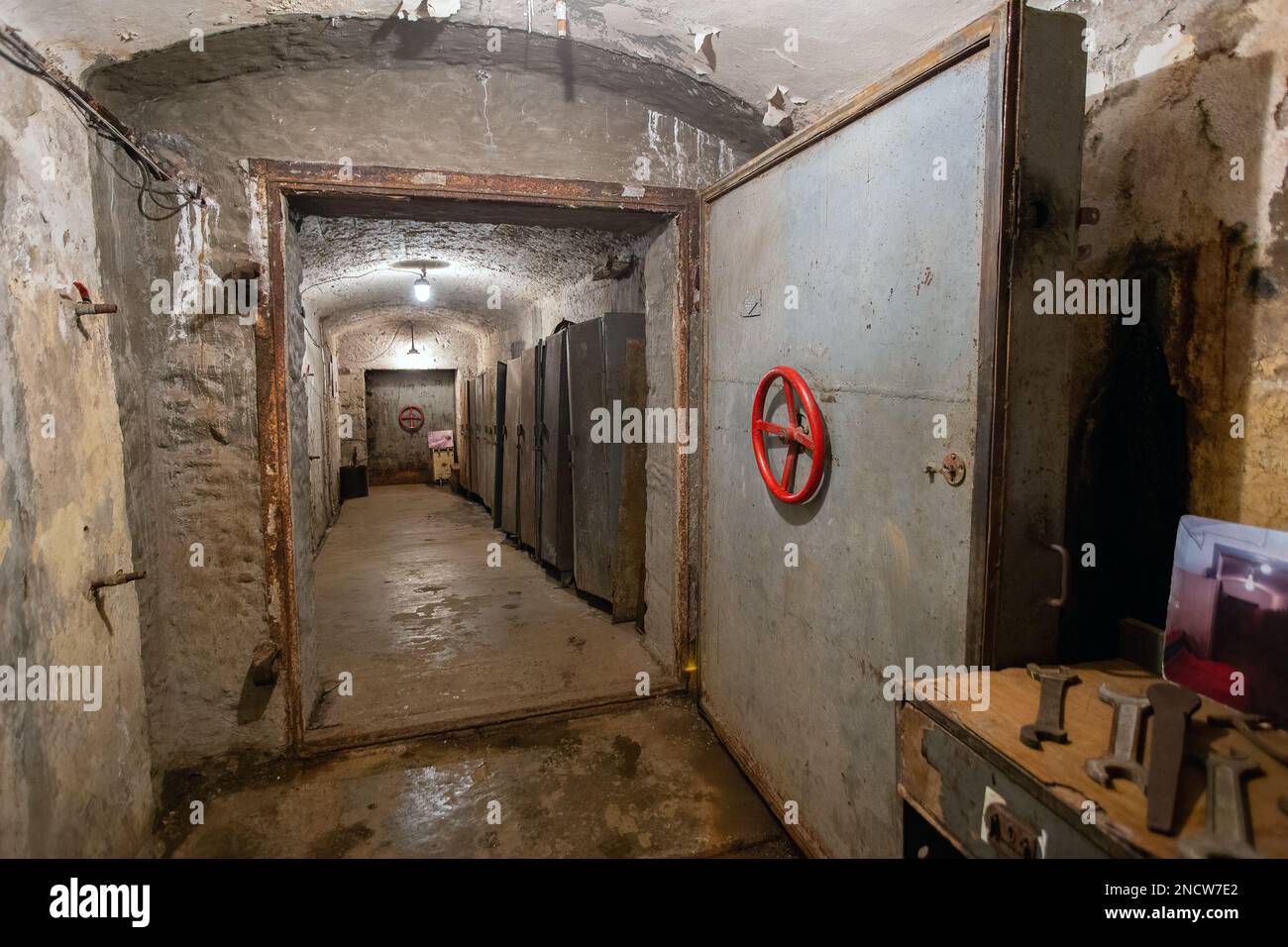 Hermetic rusty door of the bunker in underground abandoned tunnel ...