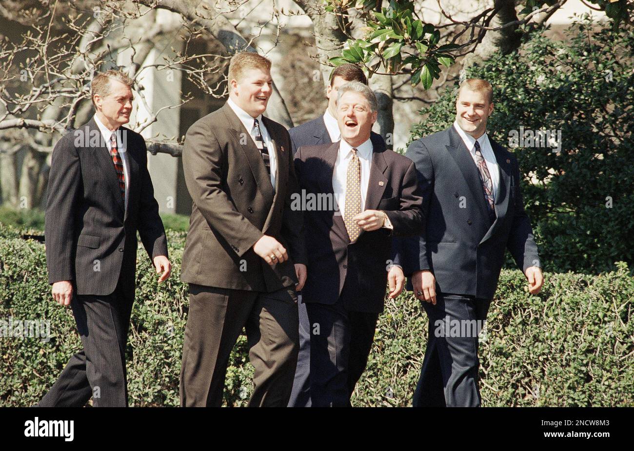 U.S. President Bill Clinton shares a laugh with Nebraska football team ...
