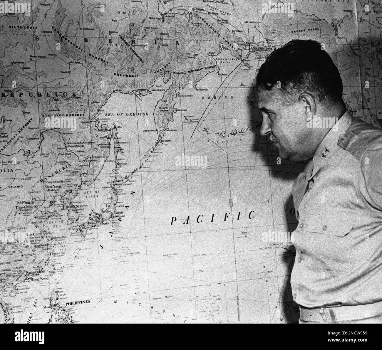 Major General Leslie Richard Groves, looks at a map of the Western ...