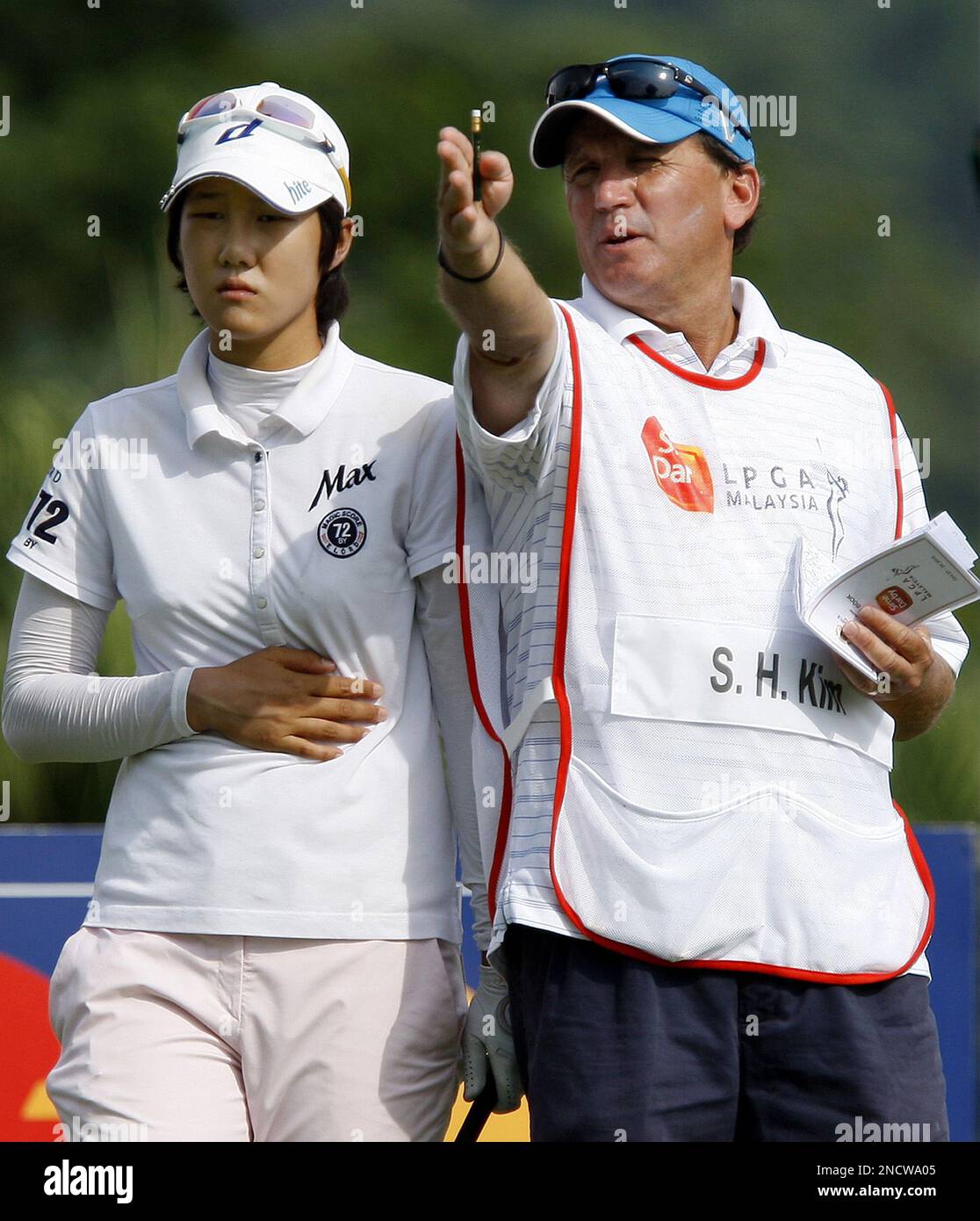 Song-Hee Kim of South Korea, left, listens to her caddy before teeing ...