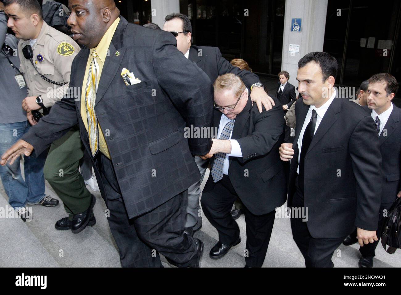 Former Bell, Calif., city manager Robert Rizzo is escorted from court ...
