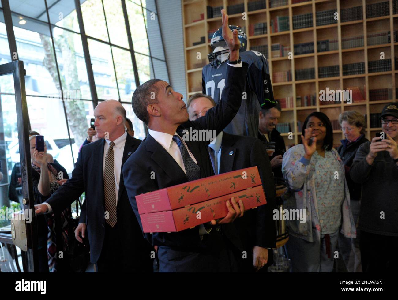 President Barack Obama waves to people on the second level as he ...
