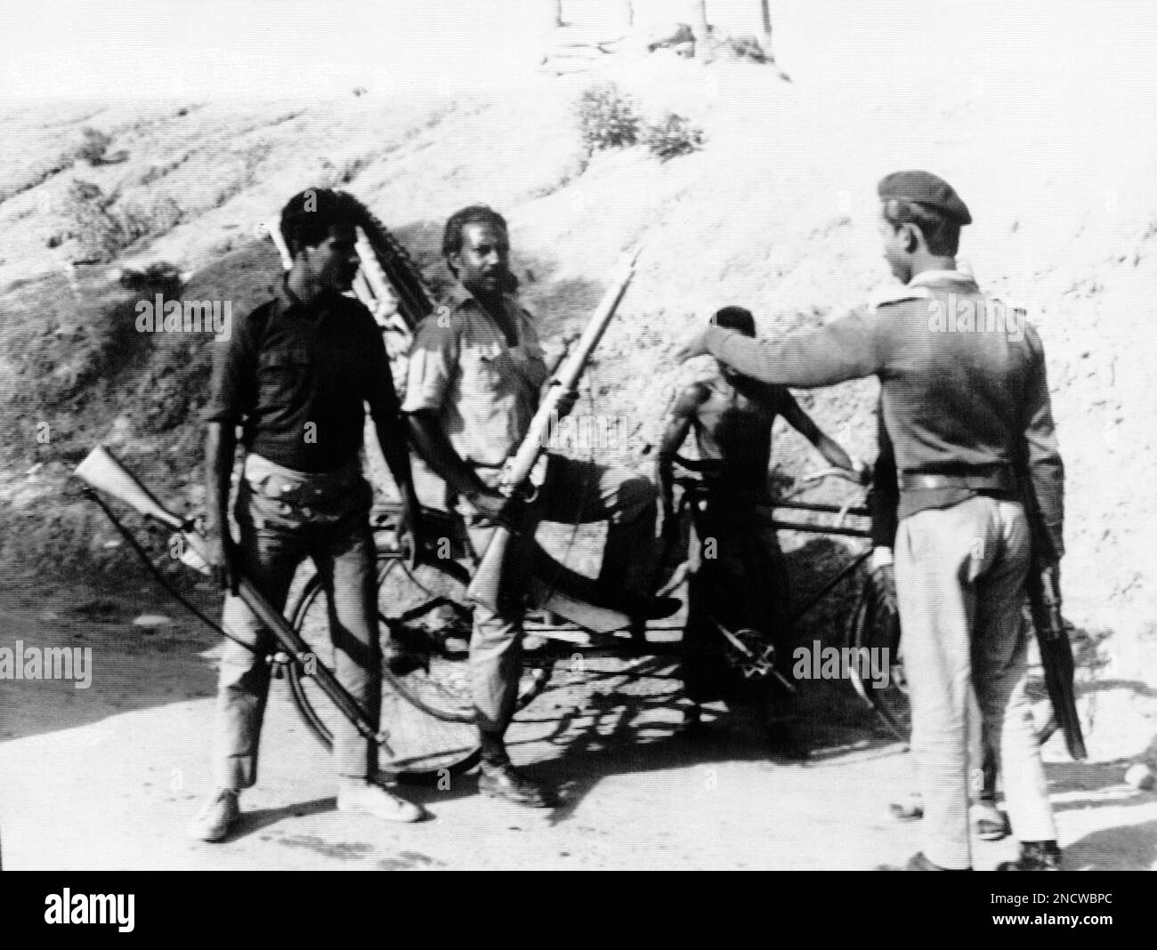 A Pakistani sergeant, right, directs two members of the militia to ...