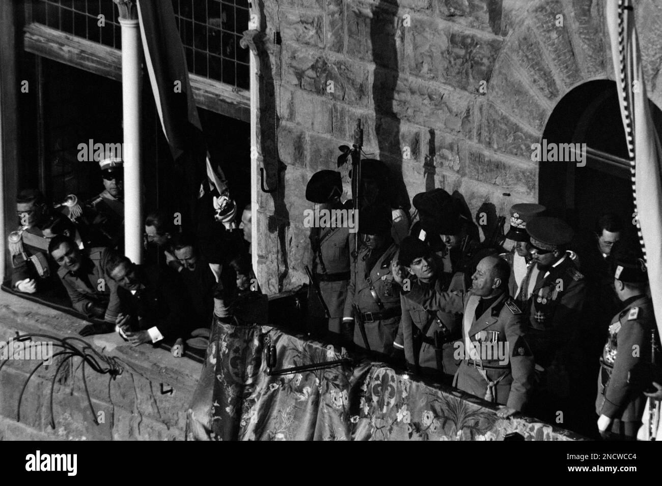 Italian leader Benito Mussolini addressing the crowds from a balcony of ...