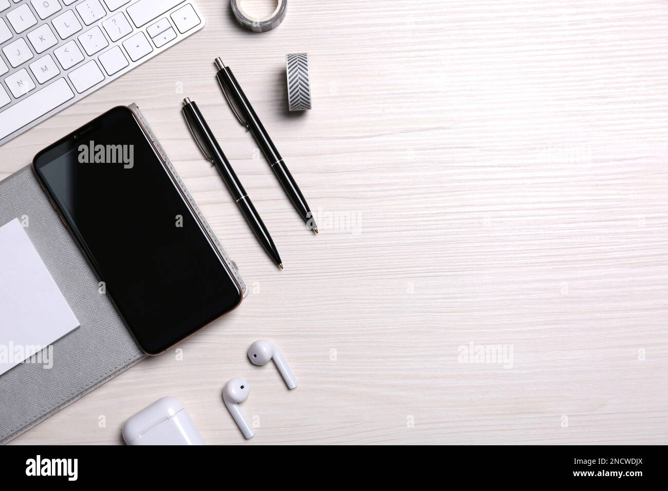 Flat lay composition with mobile phone on wooden table. Space for text ...
