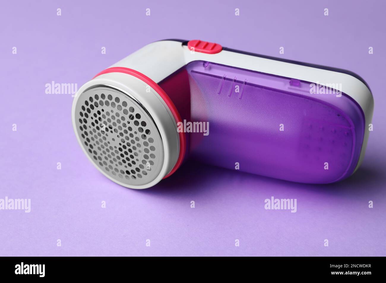 Modern fabric shaver for lint removing on purple background Stock Photo ...