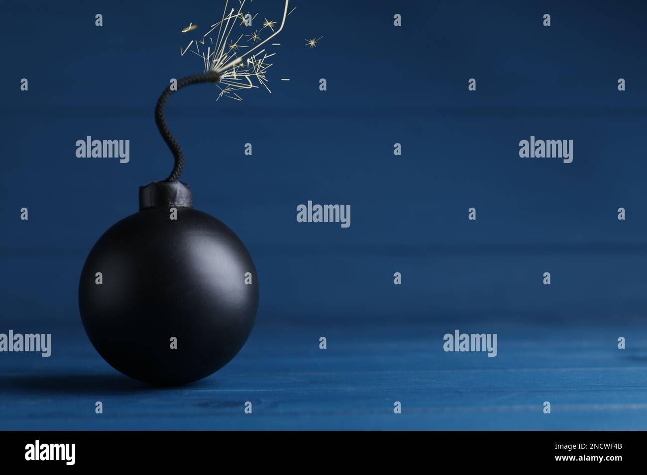 Old fashioned fuse bomb on blue wooden table. Space for text Stock ...