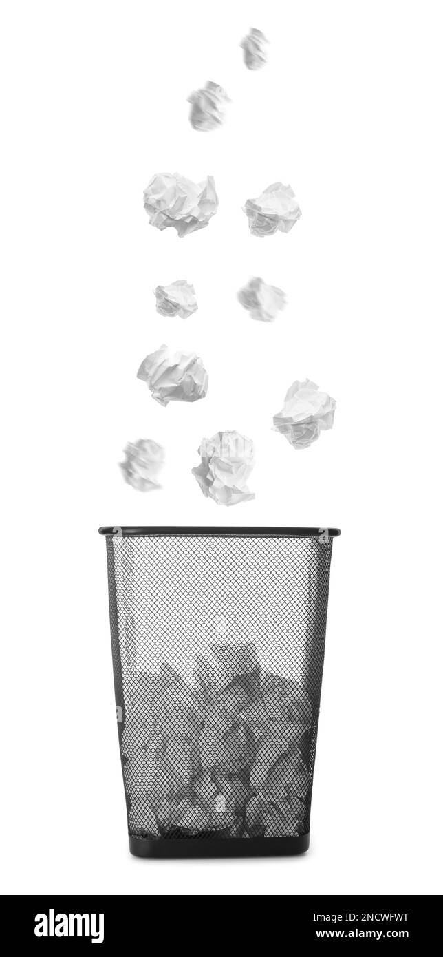 Crumpled paper falling into trash bin on white background Stock Photo ...