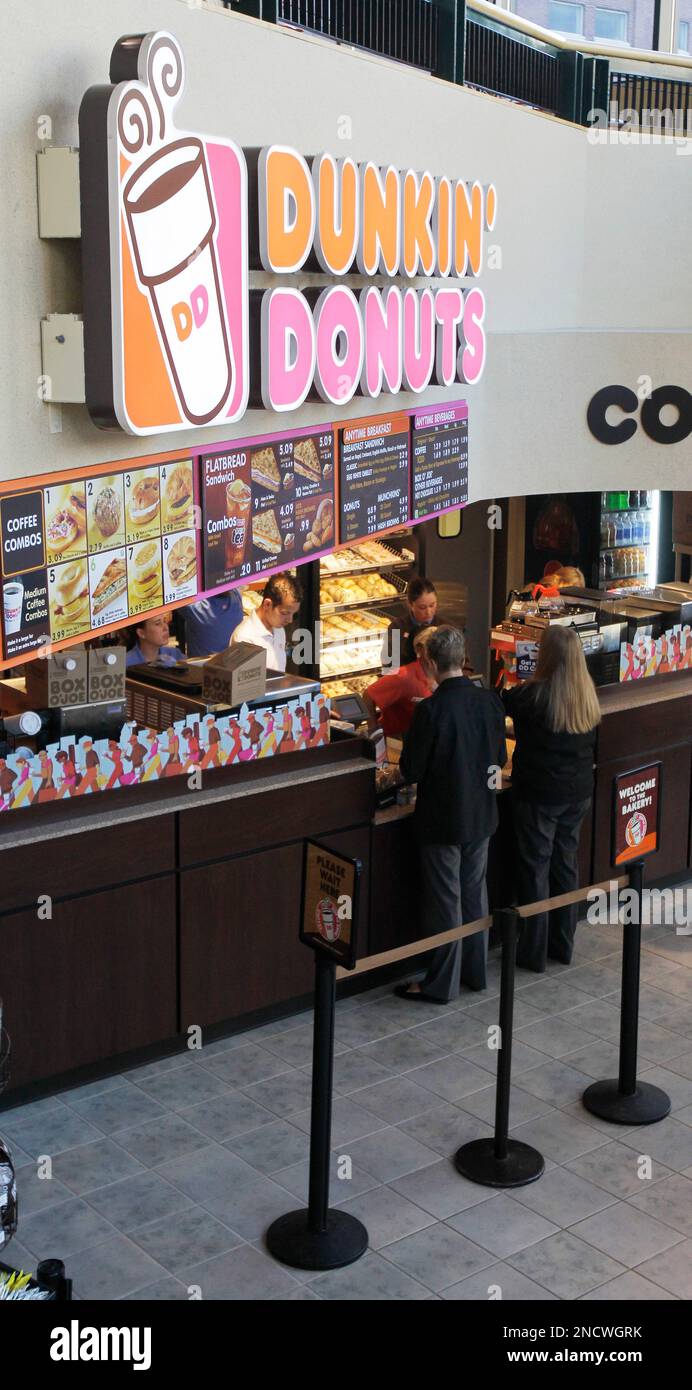 Patrons place an order at a Dunkin Donuts store located in Conseco ...