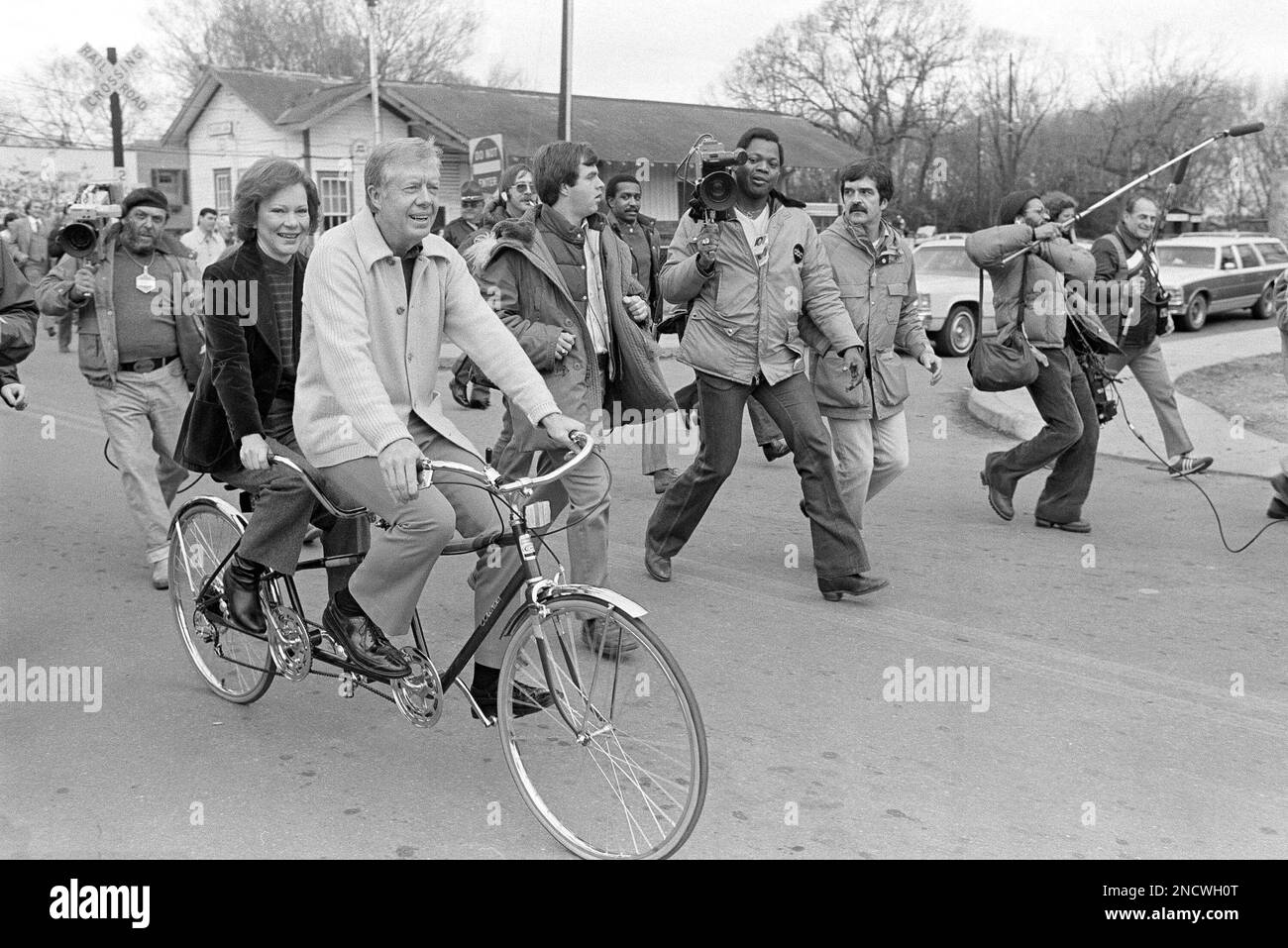 President Jimmy Carter and his wife, Rosalynn, ride on a bicycle built ...