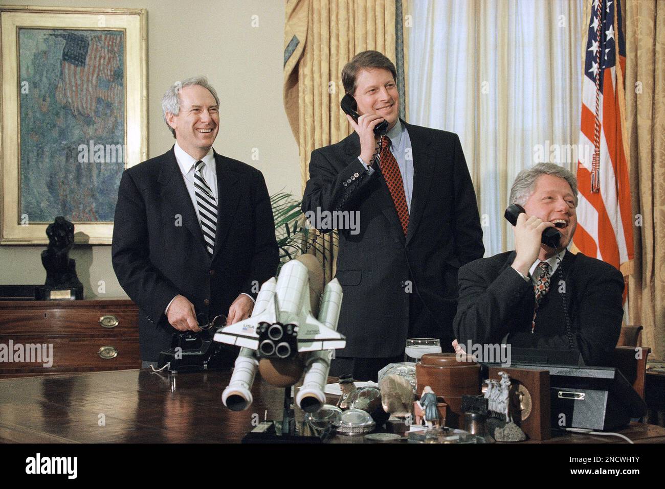 President Bill Clinton and Vice President Al Gore laugh as they look at ...