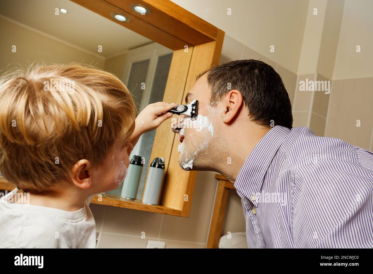Close up of kid helping his father to shave with razor Stock Photo - Alamy