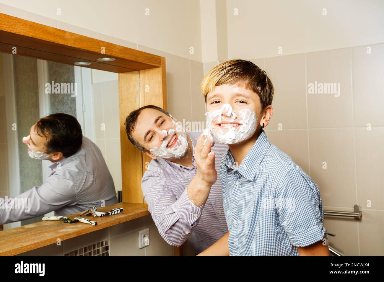 Dad and kid preparing to shave together foaming face smiling Stock ...
