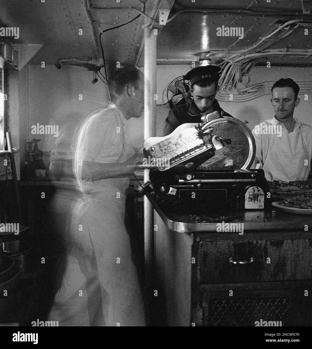 Crewmen working on ship during WWII as they leave the United States ...