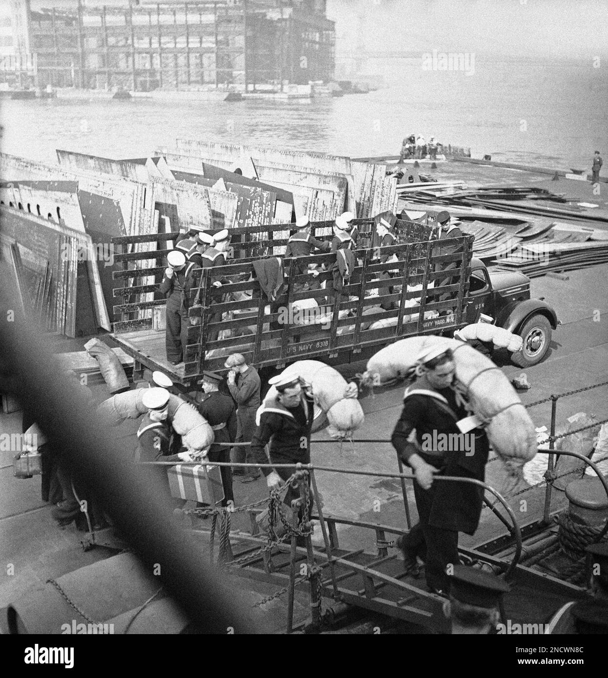 British sailors bring their seabags aboard lend-lease vessel, ready to ...