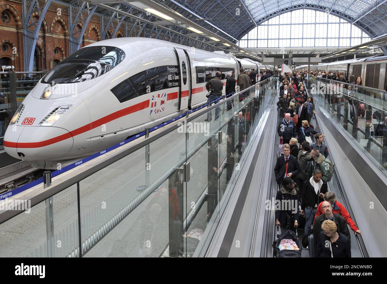 Passengers walk by the German Intercity Express (ICE) high speed train ...