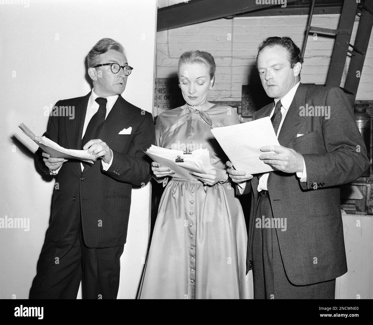 Claude Rains left, Marlene Dietrich, and Van Heflin reviewing their ...